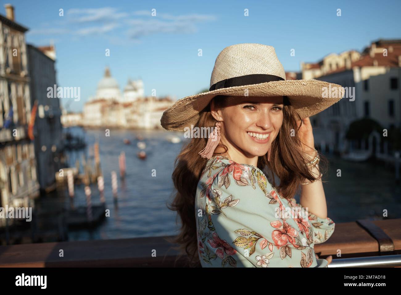 Portrait of happy elegant woman in floral dress with hat on Accademia ...