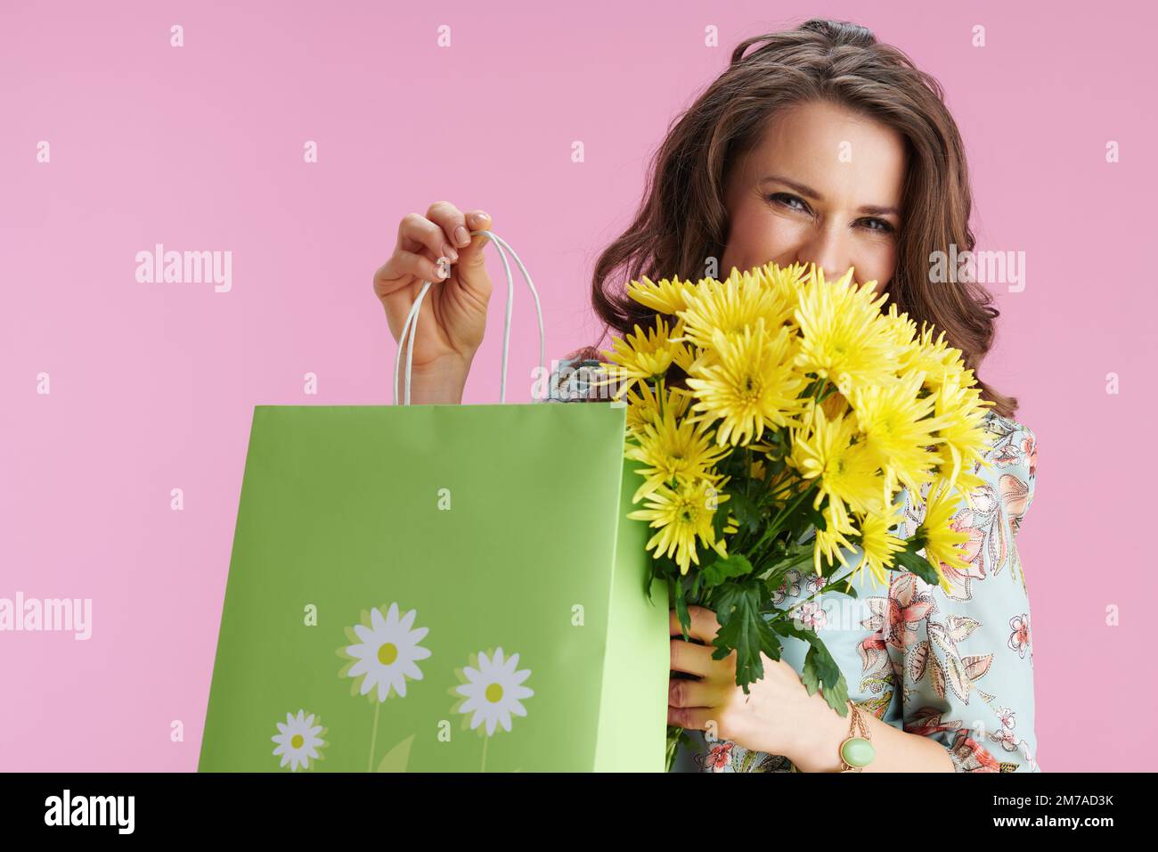 happy young woman with long wavy brunette hair with yellow ...