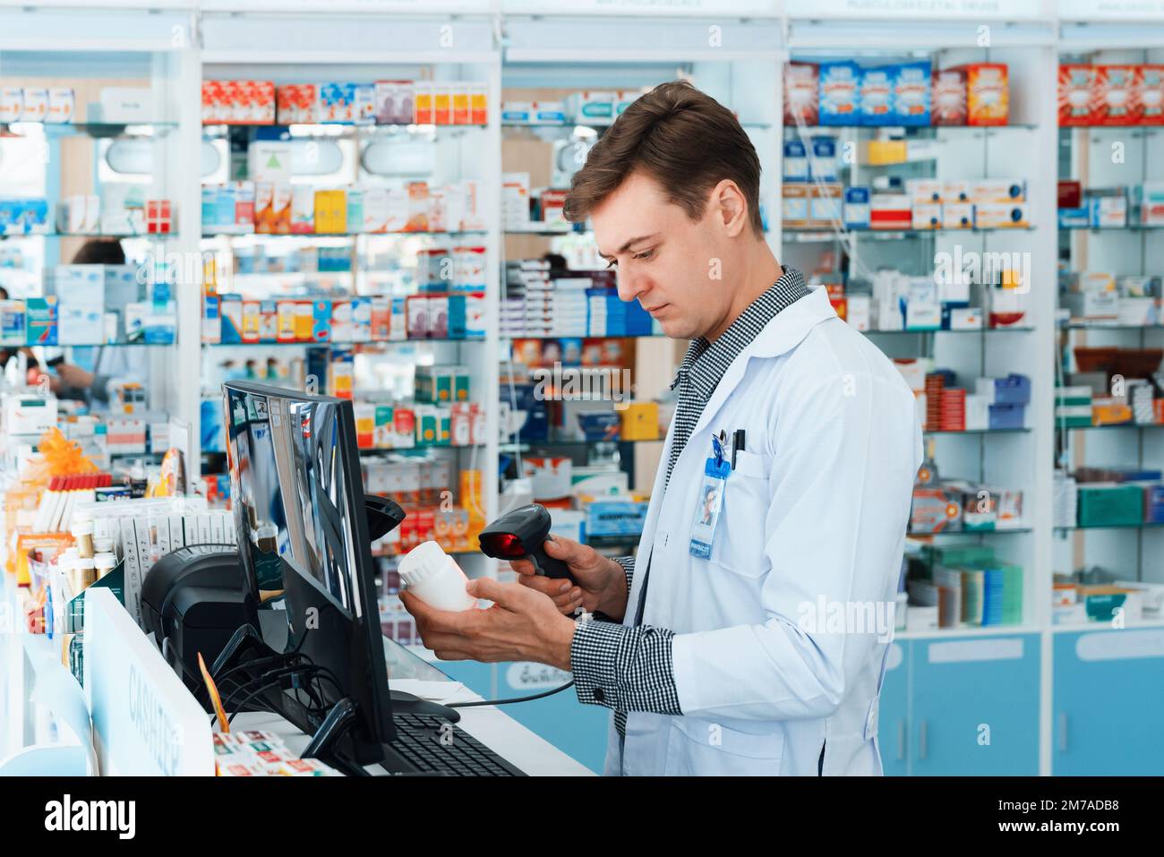 Pharmacist scanning medication scanner hi-res stock photography and ...