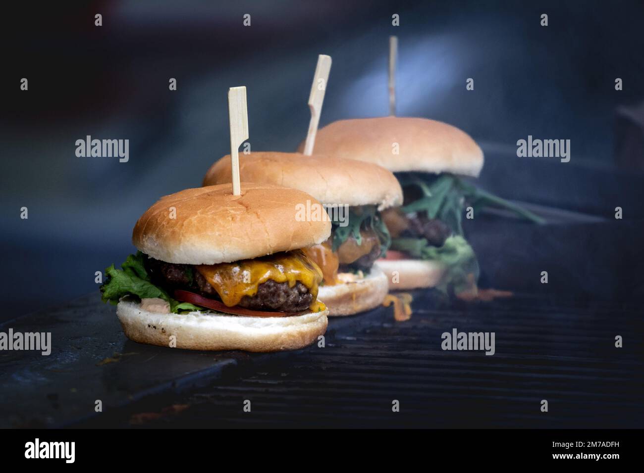 Picture of a bunch of hamburgers, cheesburgers, ready to get served and ...