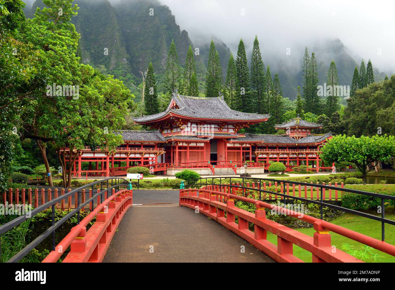 A path leads to the Byodo In Temple in Oahu as it sits under a fog ...