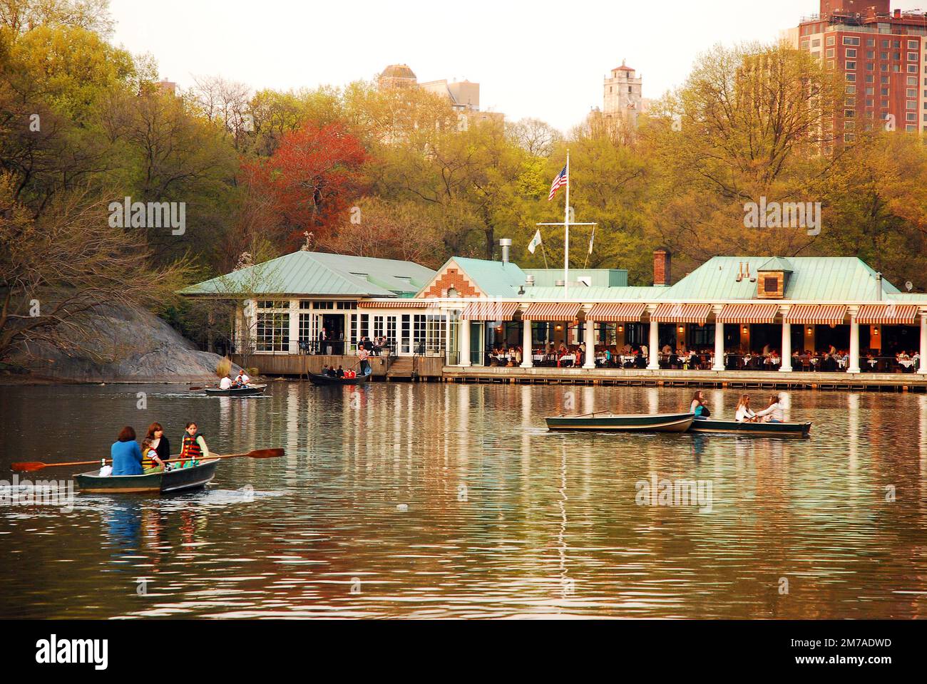 People enjoy a warm spring day rowing on the lake in New York’s Central ...