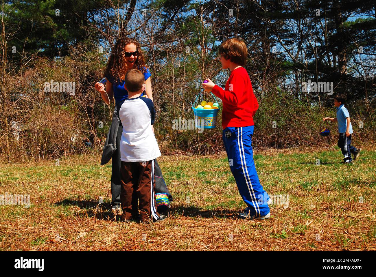 Two Boys Show Their Mother Their Finds During An Easter Egg Hunt In A 1702