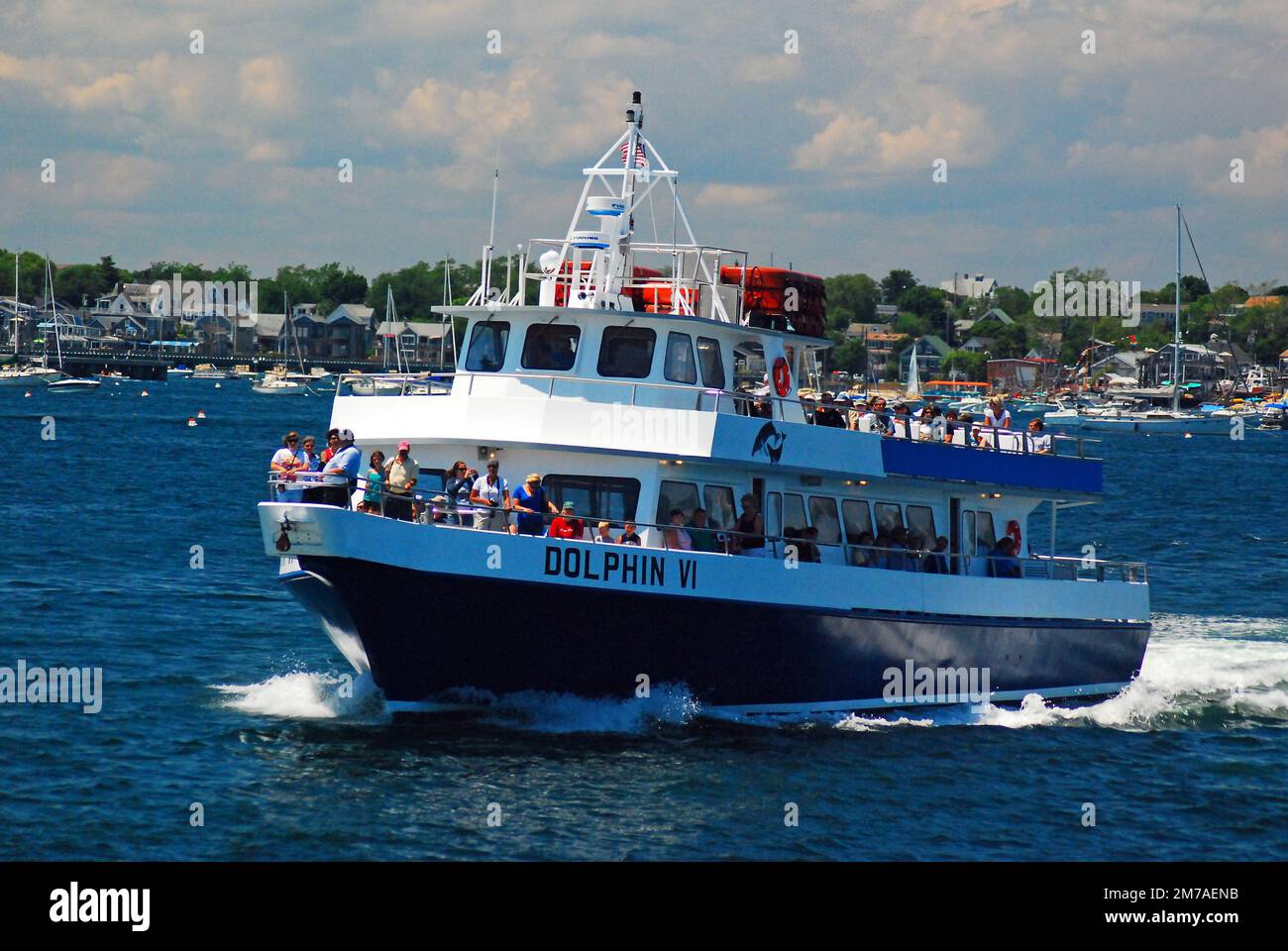 A ferry transports passengers on a summer vacation day on their way to ...
