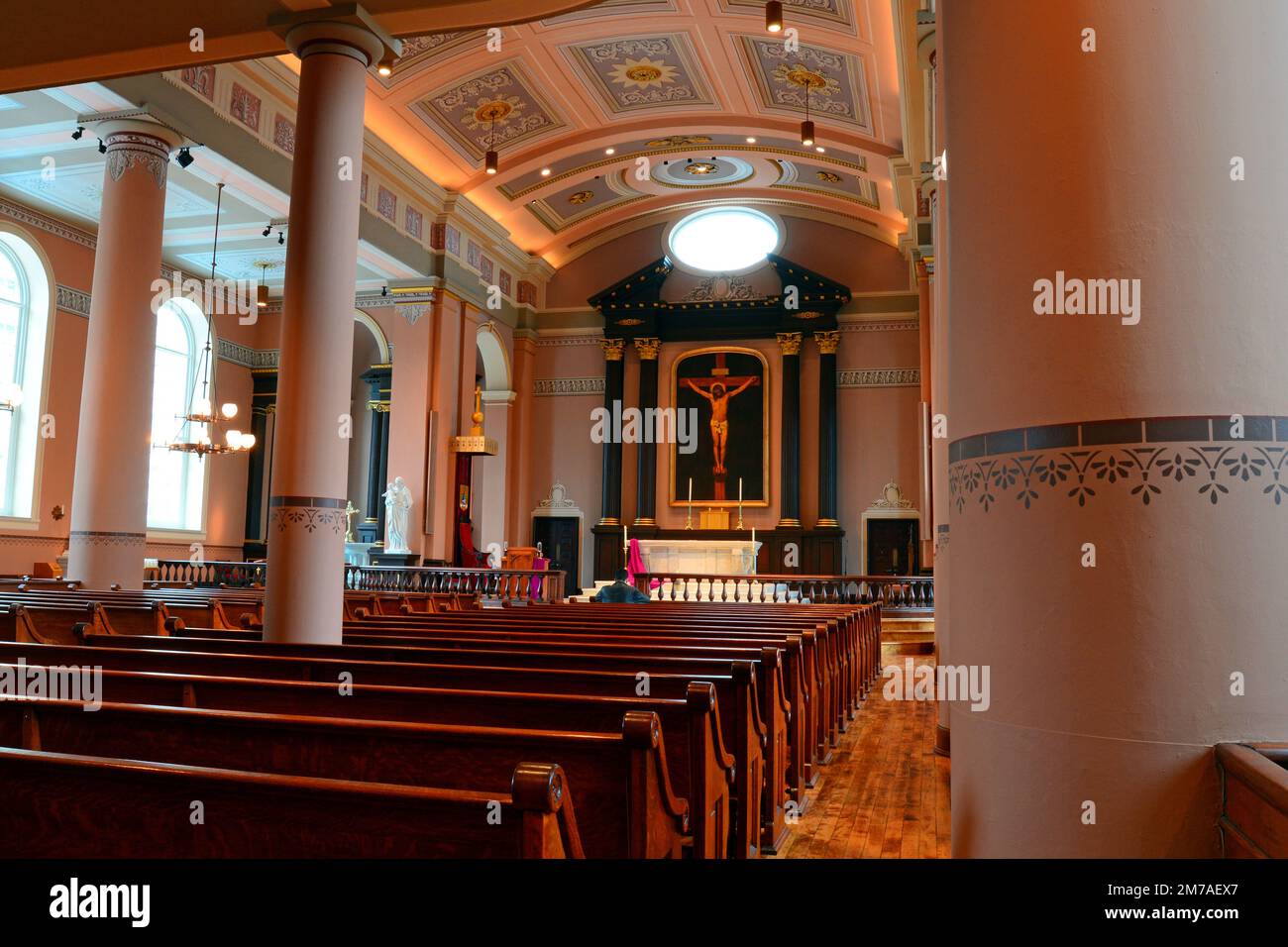 Columns and pews lead to the altar in the interior of the St Louis ...