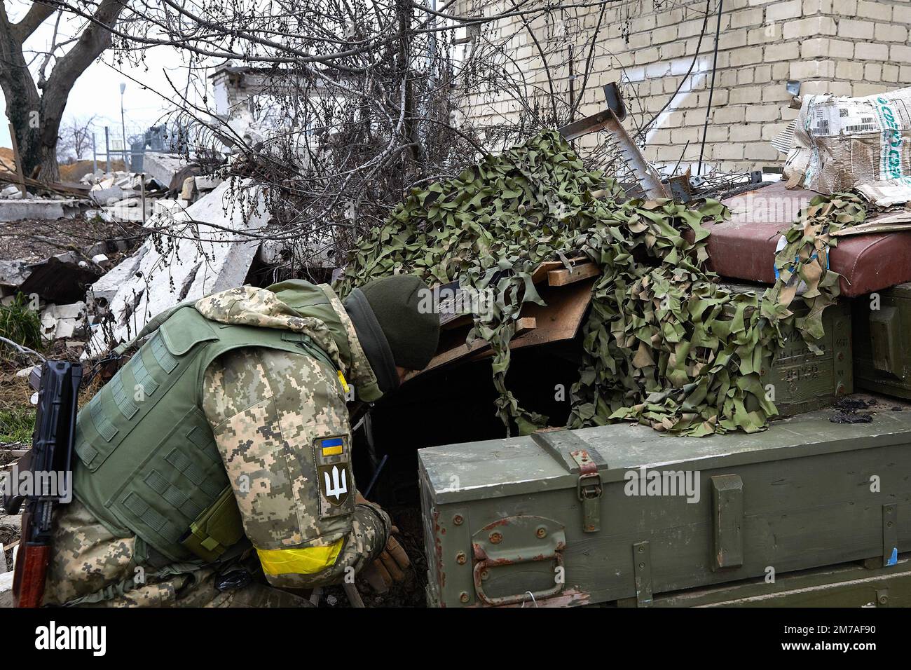Kherson, Ukraine. 08th Jan, 2023. A soldier enters one of the trenches ...