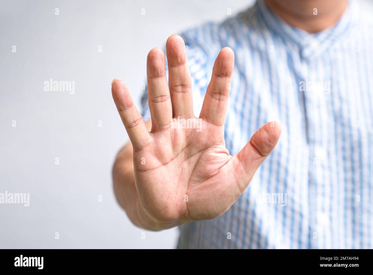 Man showing stop sign gesture with his hand Stock Photo - Alamy
