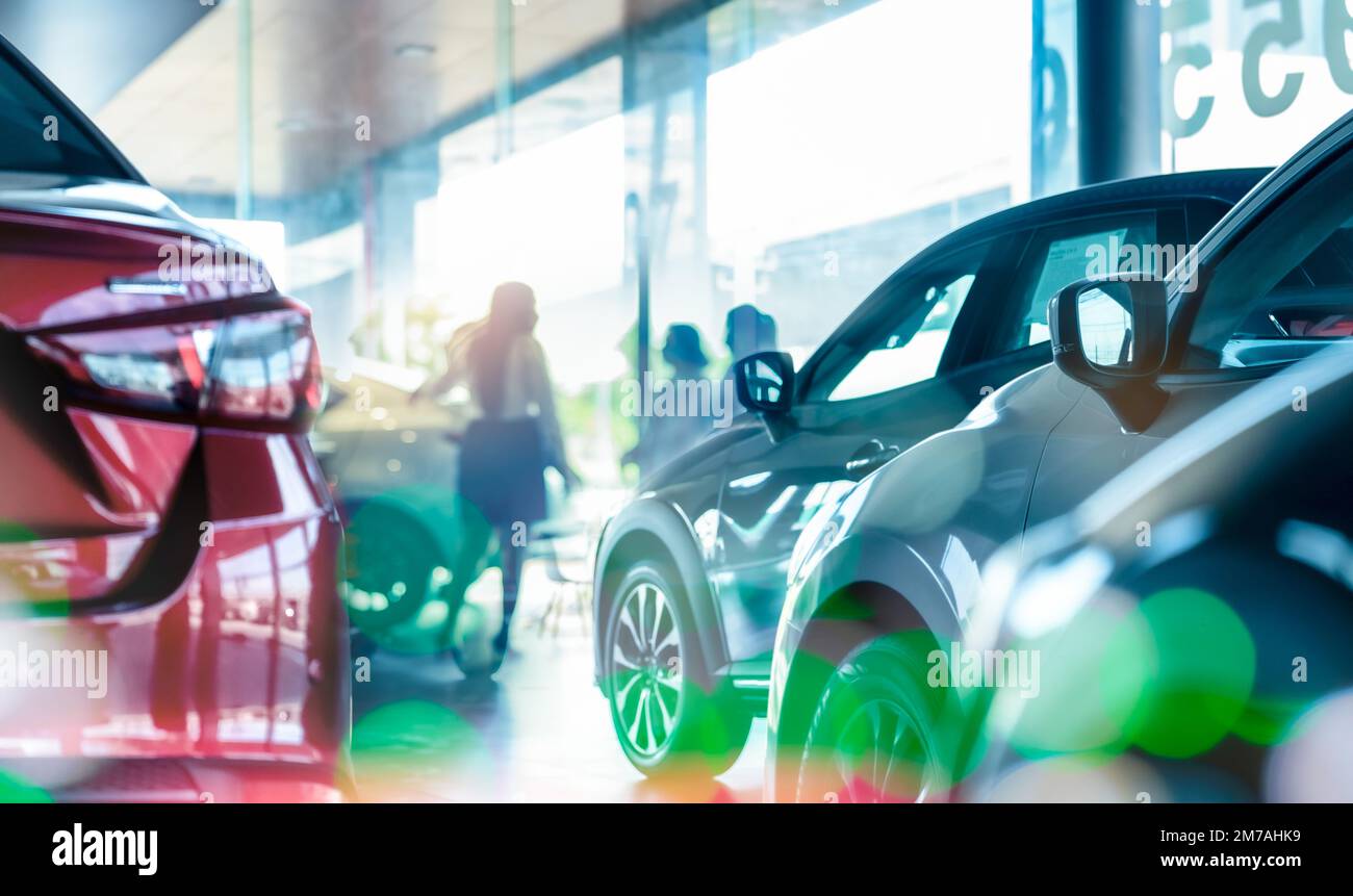 New SUV car in modern luxury showroom on blur saleswoman and customer ...