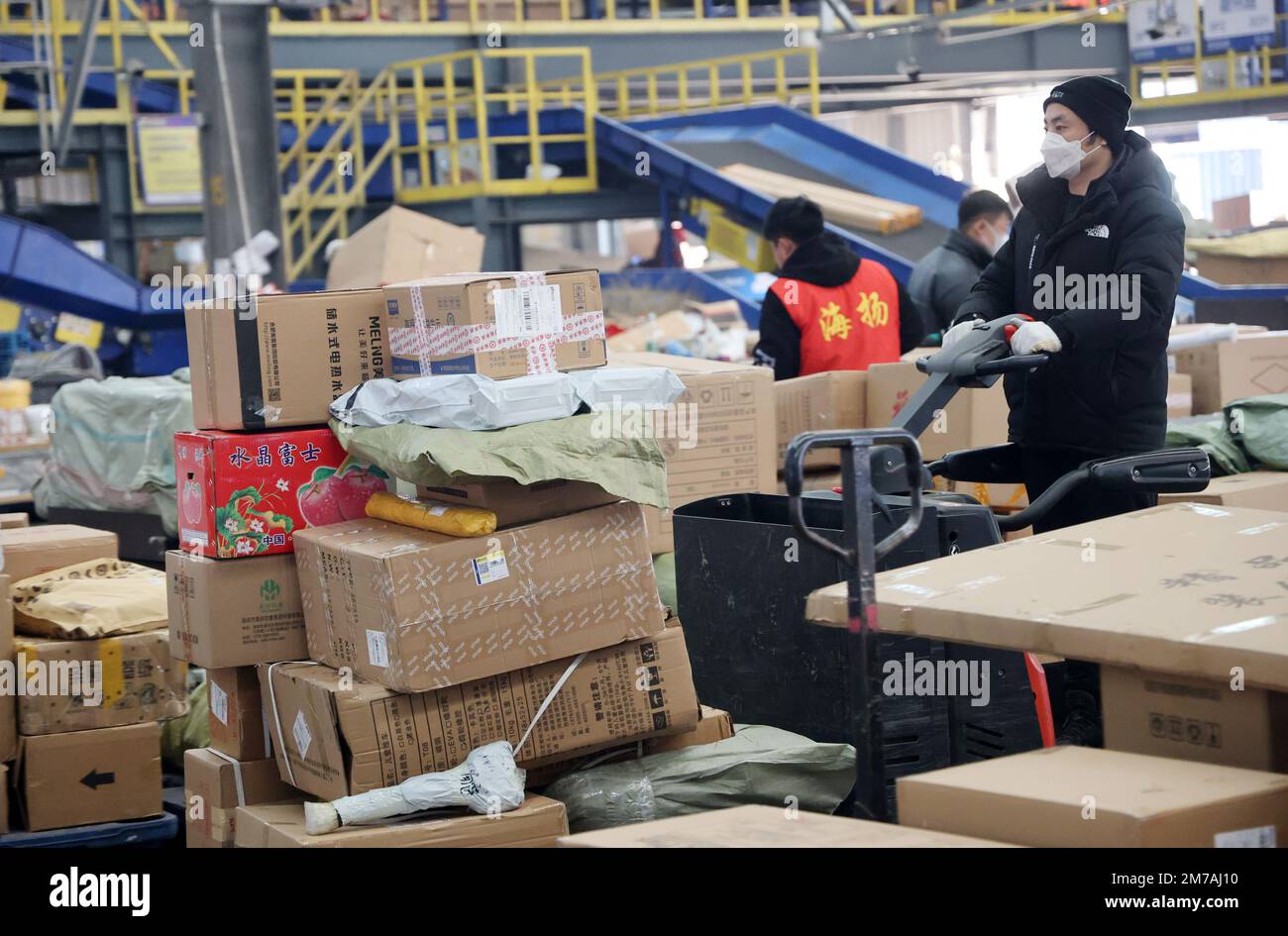 NANTONG, CHINA- JANUARY 9, 2023 - Employees of an express delivery company handle deliveries at ...