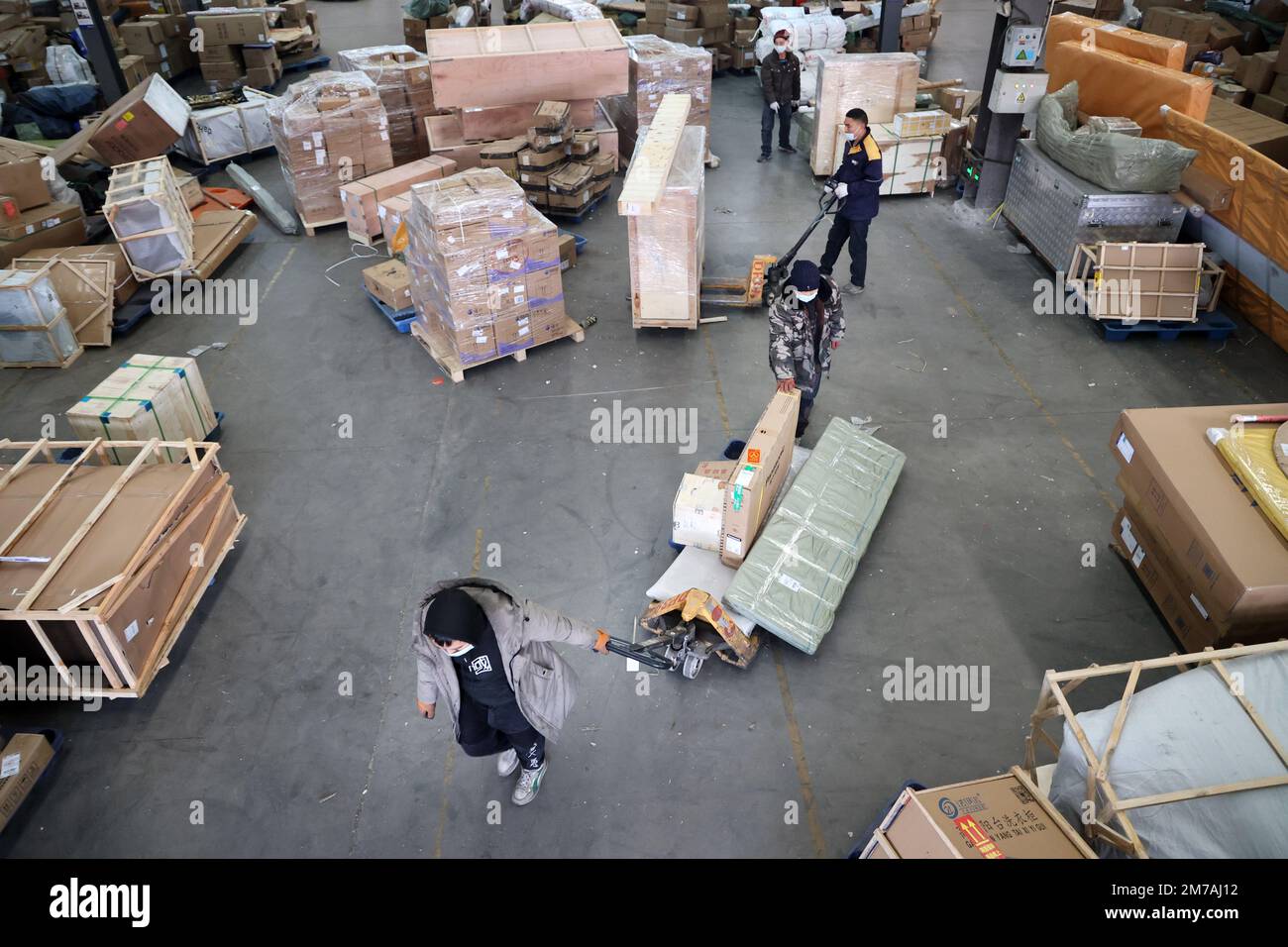 NANTONG, CHINA- JANUARY 9, 2023 - Employees of an express delivery company handle deliveries at ...