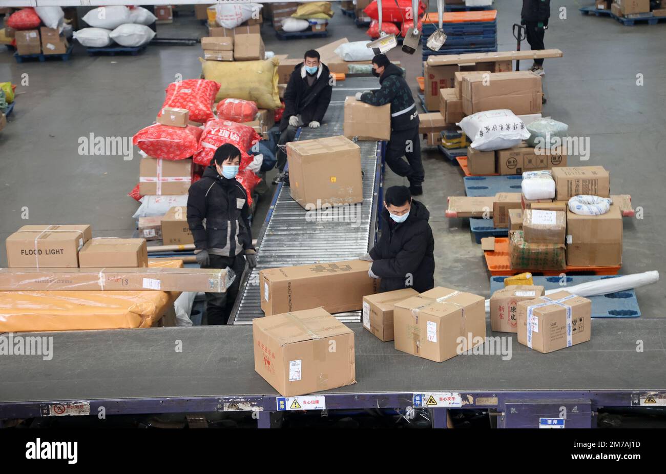 NANTONG, CHINA- JANUARY 9, 2023 - Employees of an express delivery company handle deliveries at ...