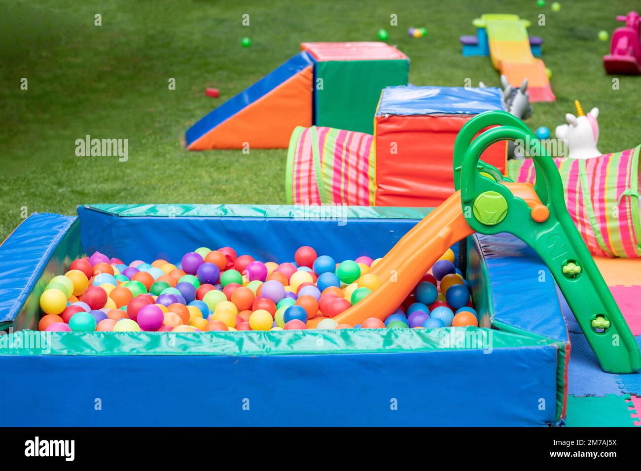 Pool of balls and games for a children's party in the garden of a house ...