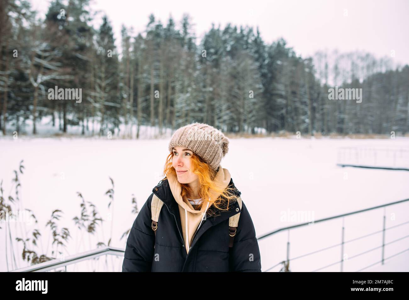 portrait of woman in winter clothes on the nature. There is a lot of ...