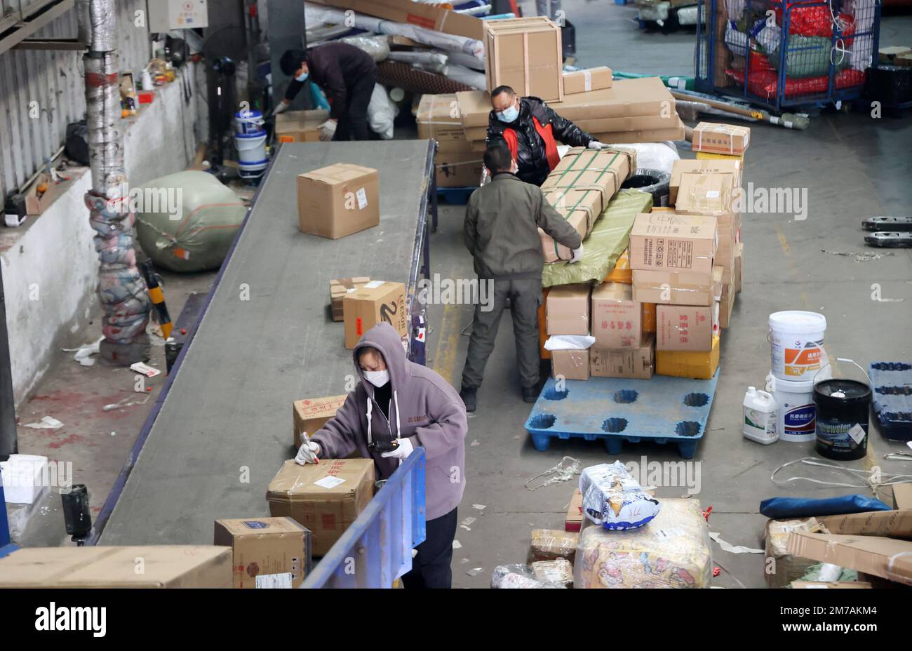 NANTONG, CHINA- JANUARY 9, 2023 - Employees of an express delivery company handle deliveries at ...