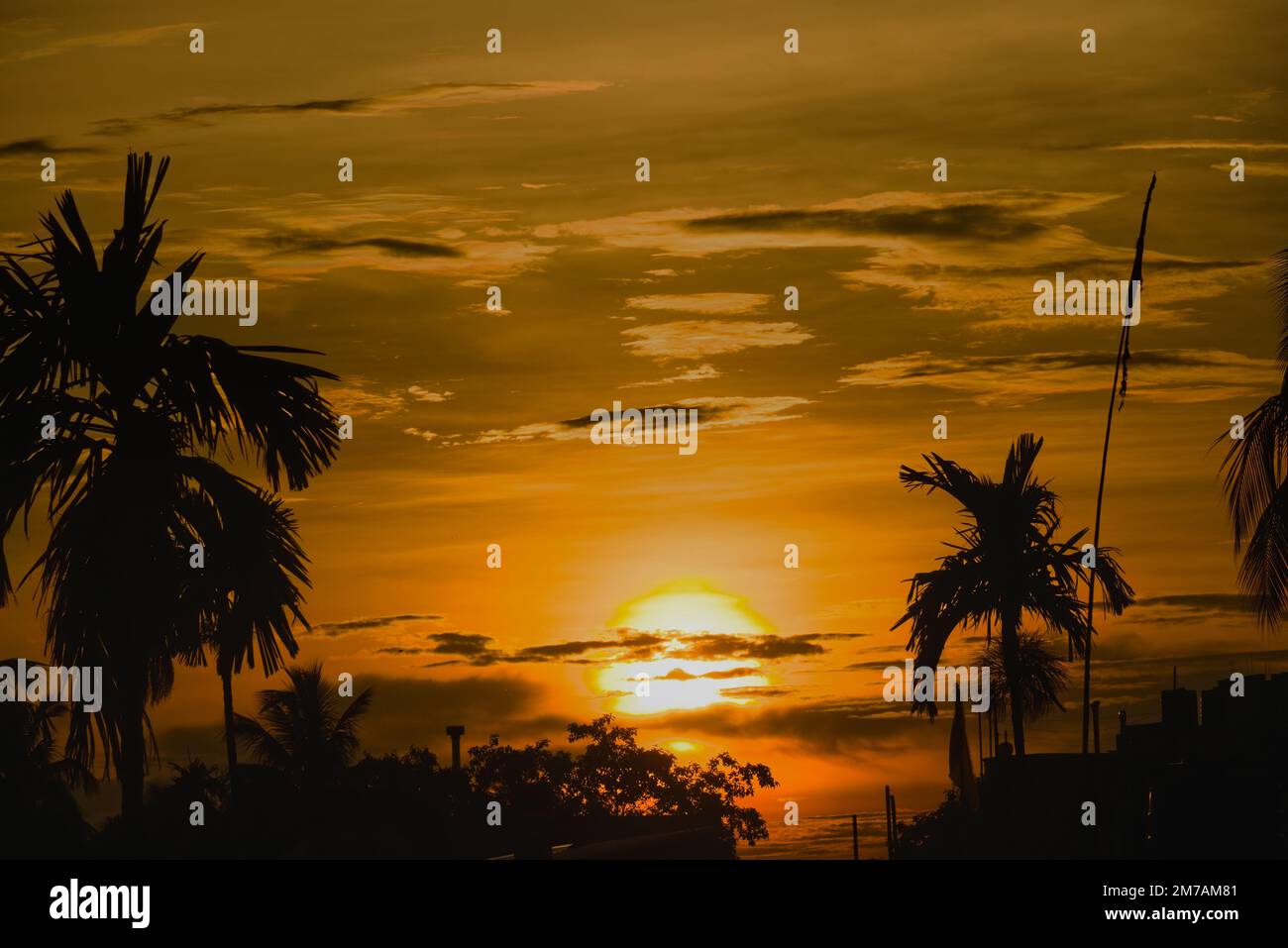 hazy sunset with clouds in india Stock Photo - Alamy