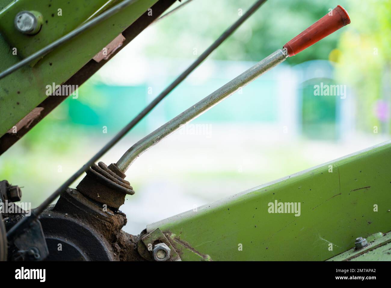 Gear lever on a walk-behind tractor close-up on a blurred background ...