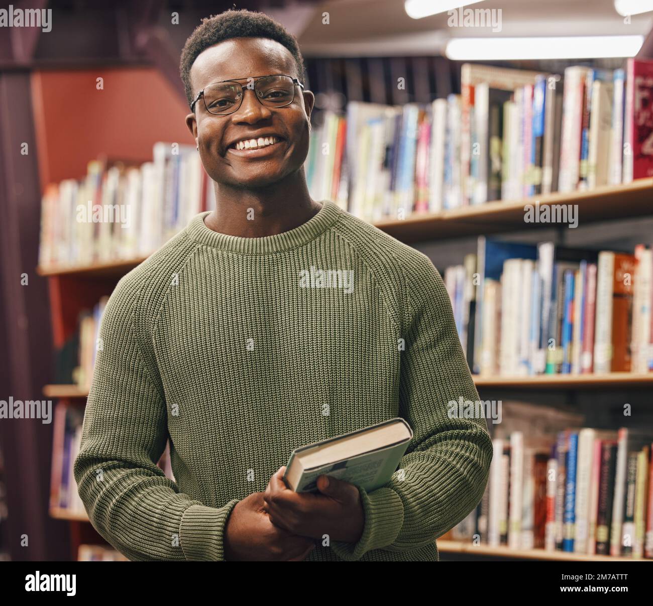 Black man, student and portrait in library for book, research and ...