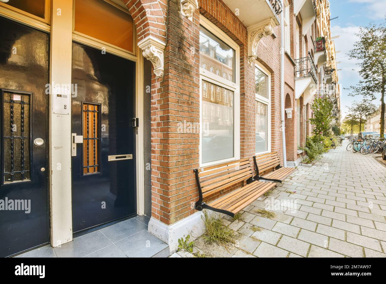 a brick building with two doors on the front and an open door to the ...
