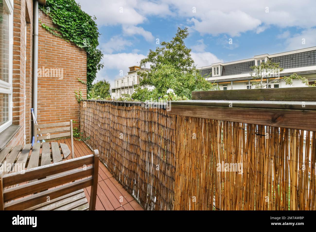 an outside area with wood fence and green plants on the side of the ...