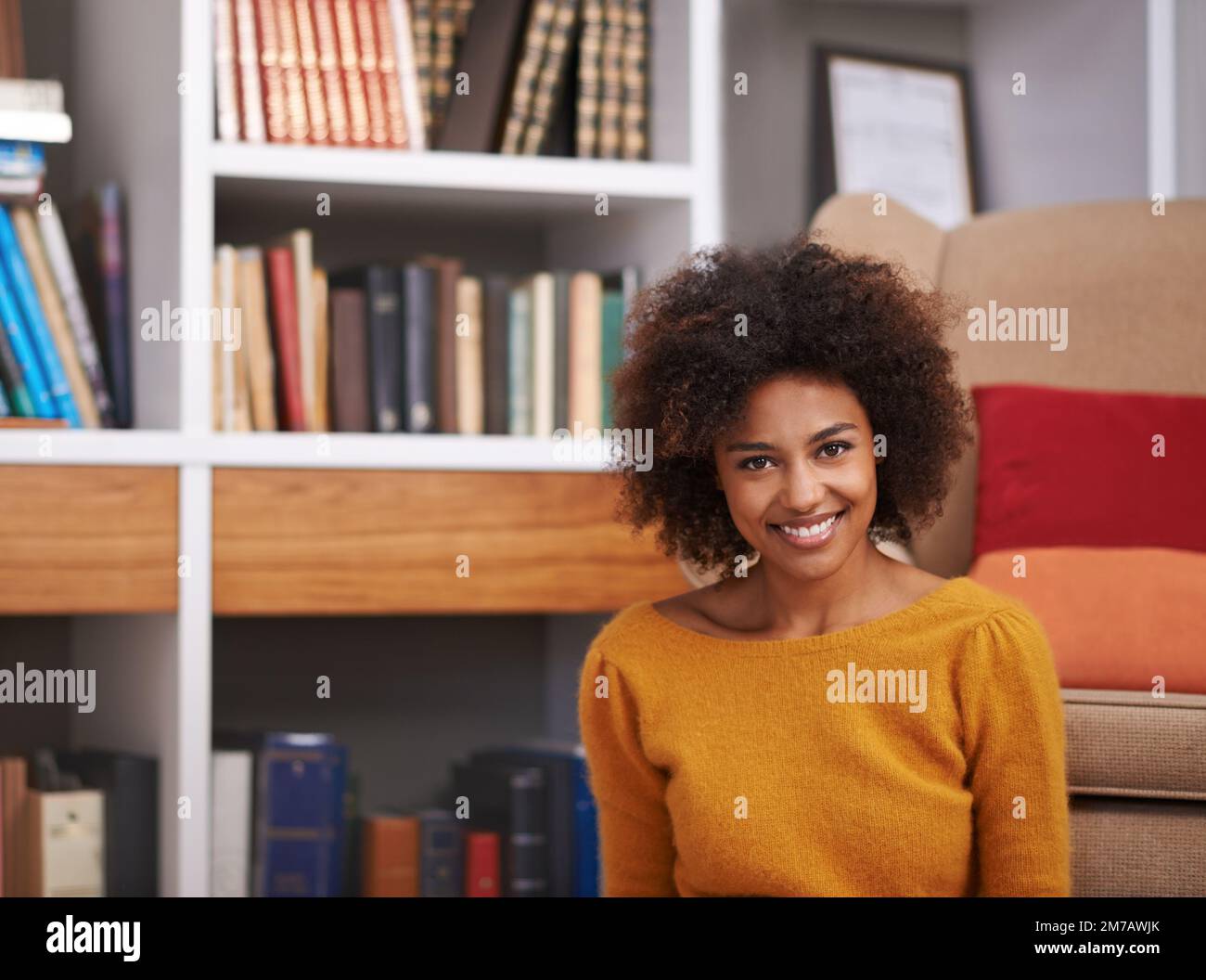 Chilling at home. Portrait of an attractive young woman smiling happily ...
