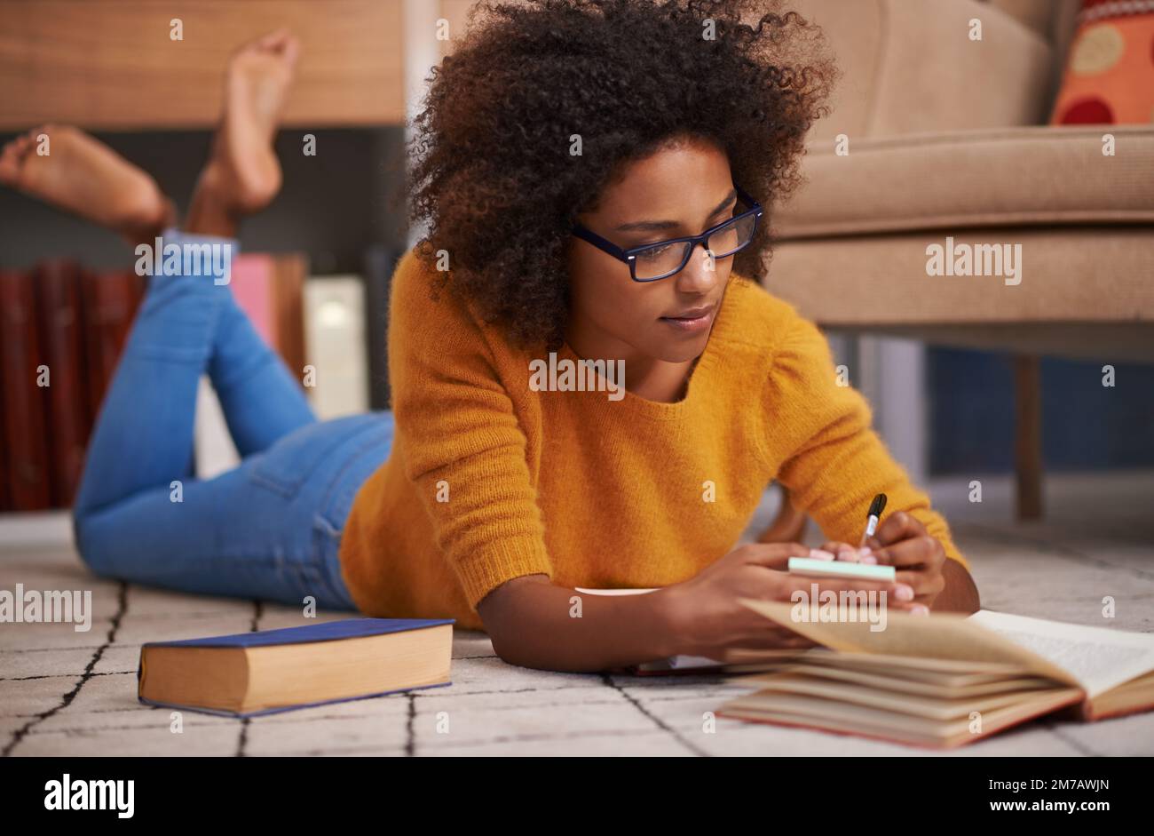 Shes an A student. an attractive young woman lying on the floor while ...