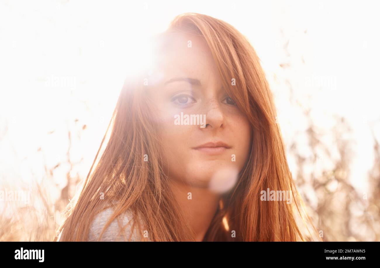 Radiant young beauty. Portrait of an attractive teenage girl in a field ...