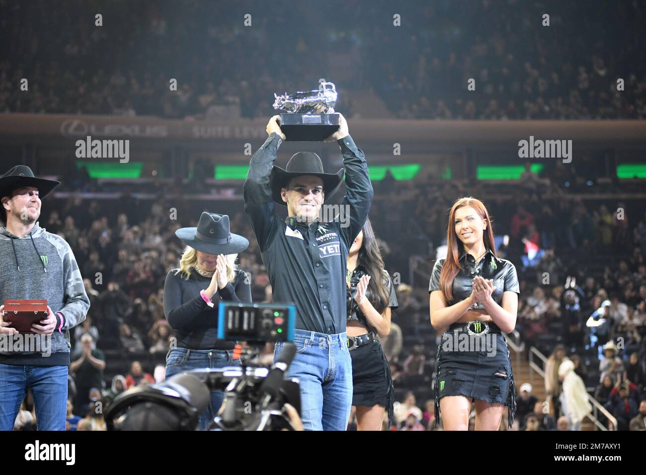 Professional Bull Rider Jose Vitor Leme is presented a trophy after ...