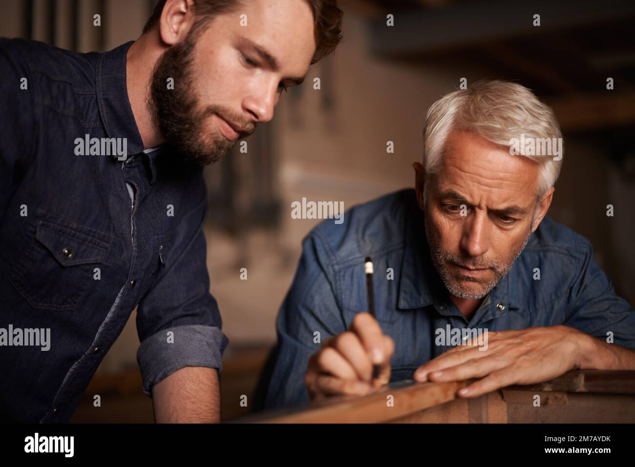 Learning the tricks of the trade. a father showing his son the tricks ...