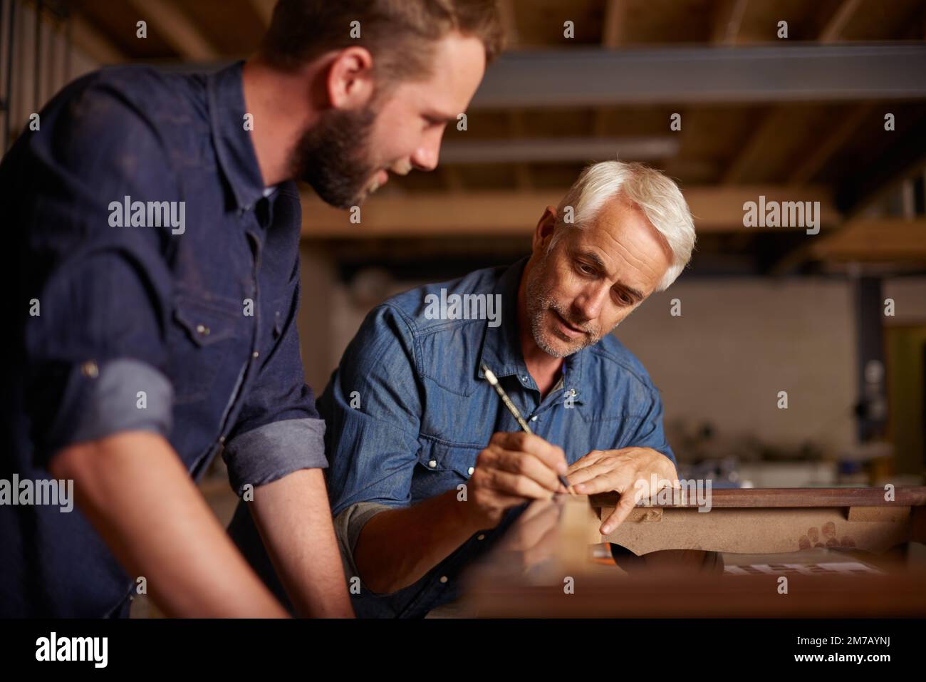 Doing some DIY with dad. a father and son working together on a ...