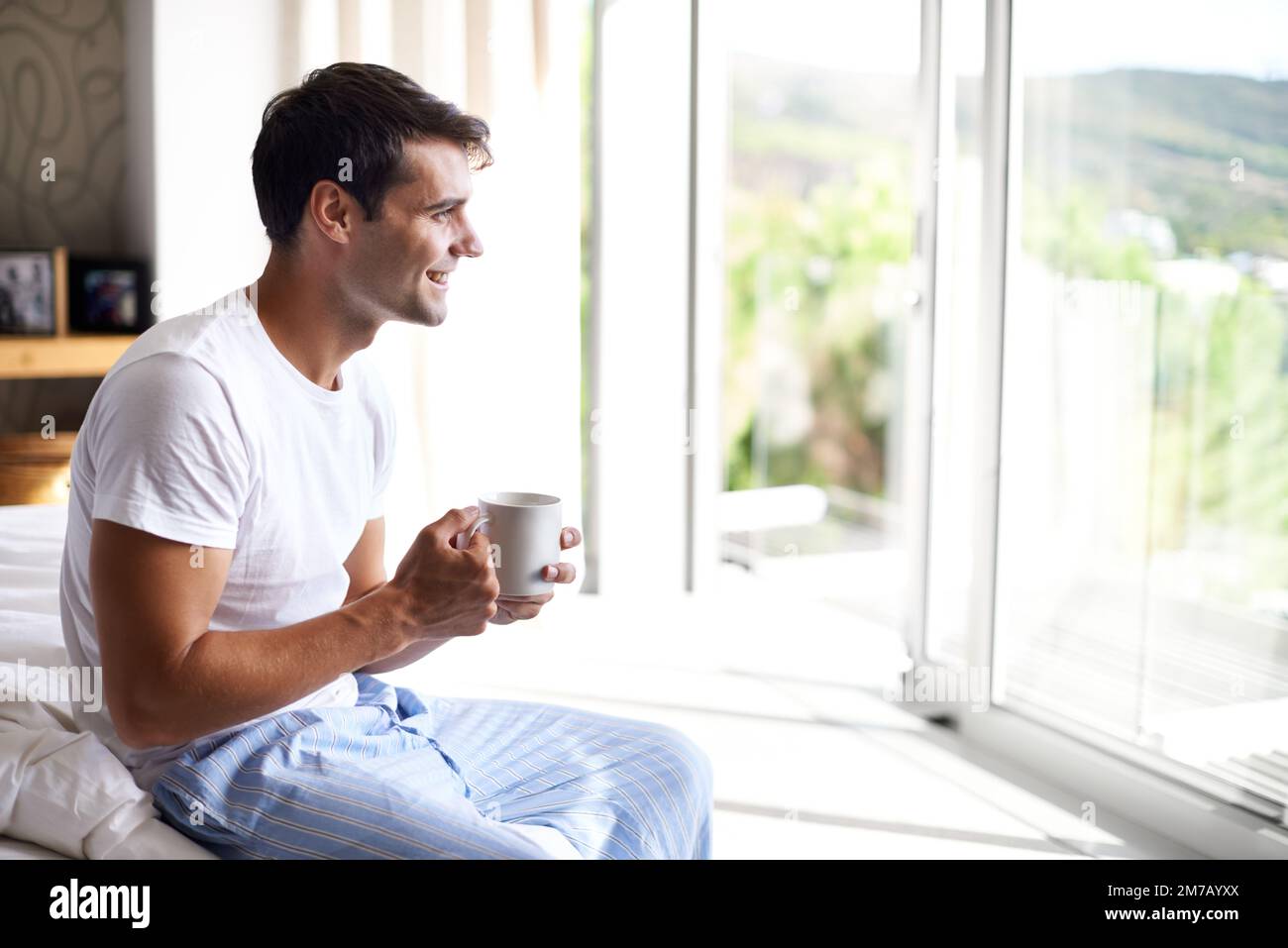 Some coffee before I get dressed. a handsome young man drinking coffee ...