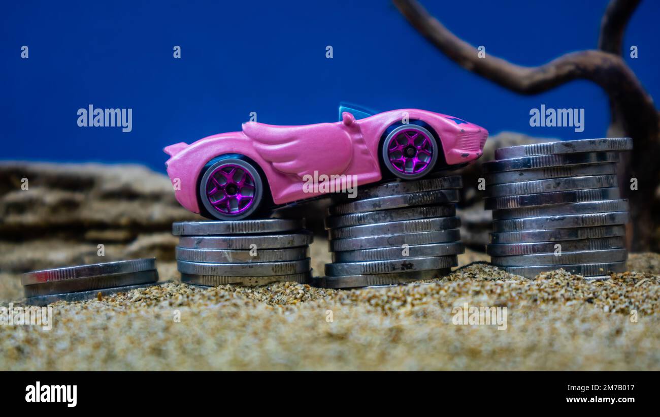 minahasa, Indonesia : January 2023, toy car on pile of coins, saving ...