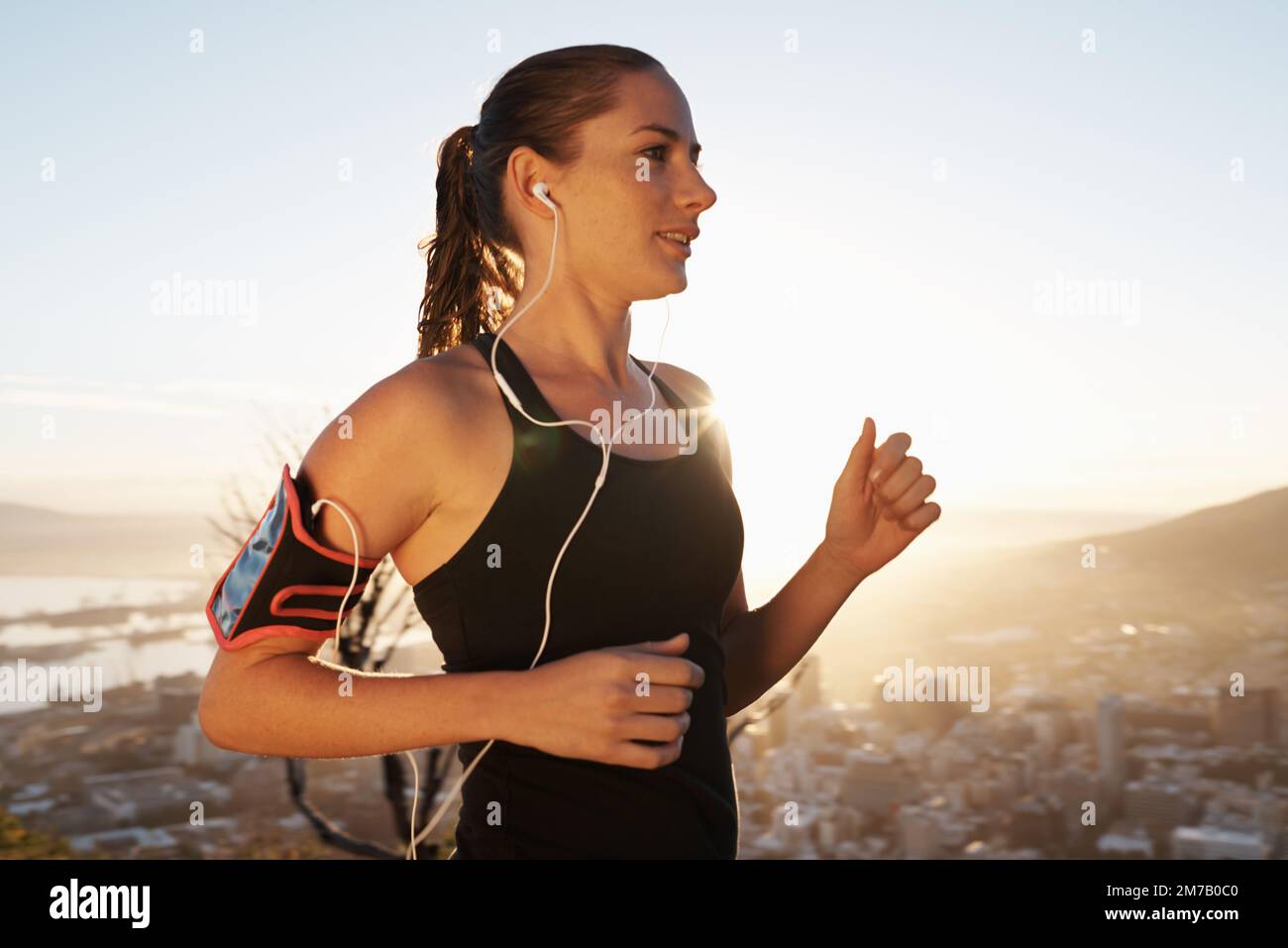 The only place to run is above the clouds. a young woman listening to ...