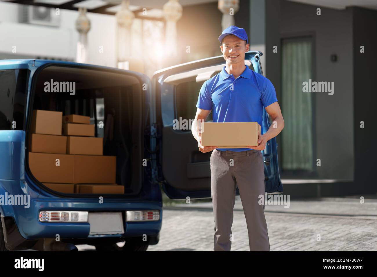 Asian courier with parcel and delivery logistic concept. Delivery man ...