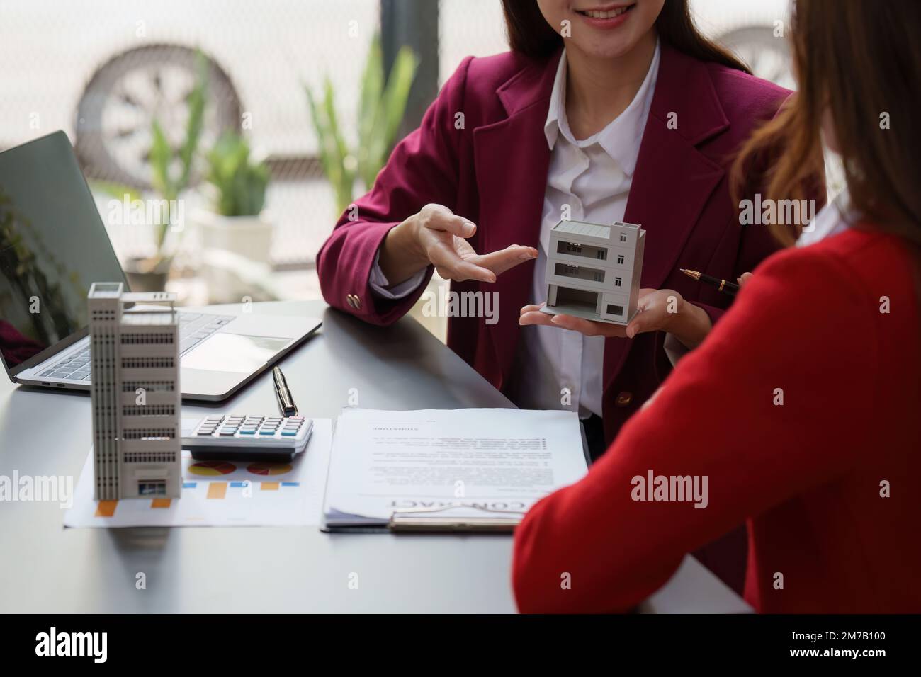 Real Estate Agent explain insurance and agreement contract to client ...