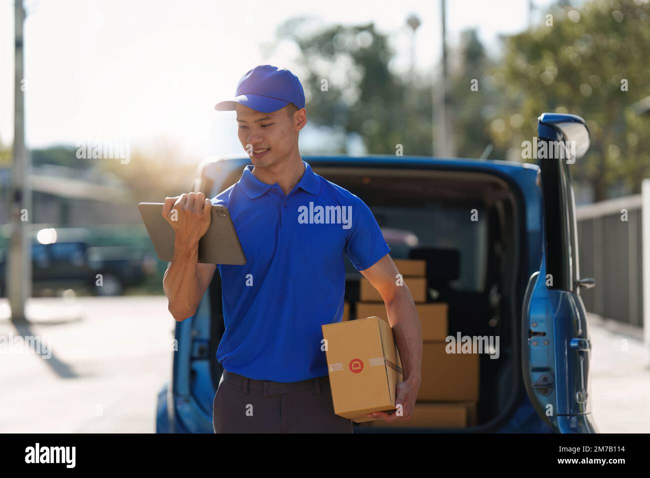 Asian courier with parcel and delivery logistic concept. Delivery man ...