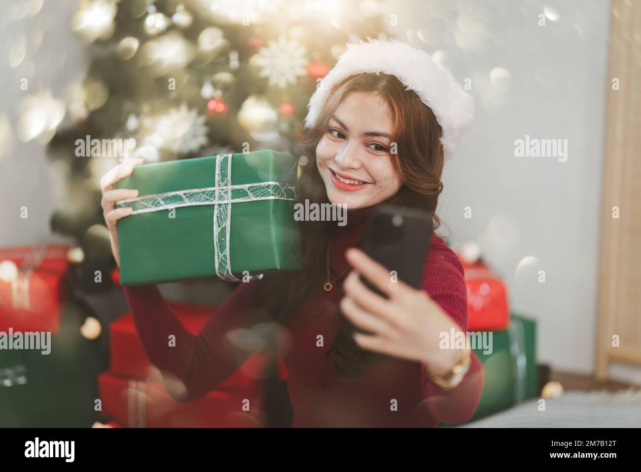 Cheerful lady surprised of the present after the opening in the gift ...