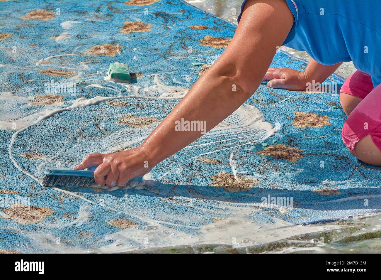 soaping the carpet, washing the carpet on the street Stock Photo - Alamy