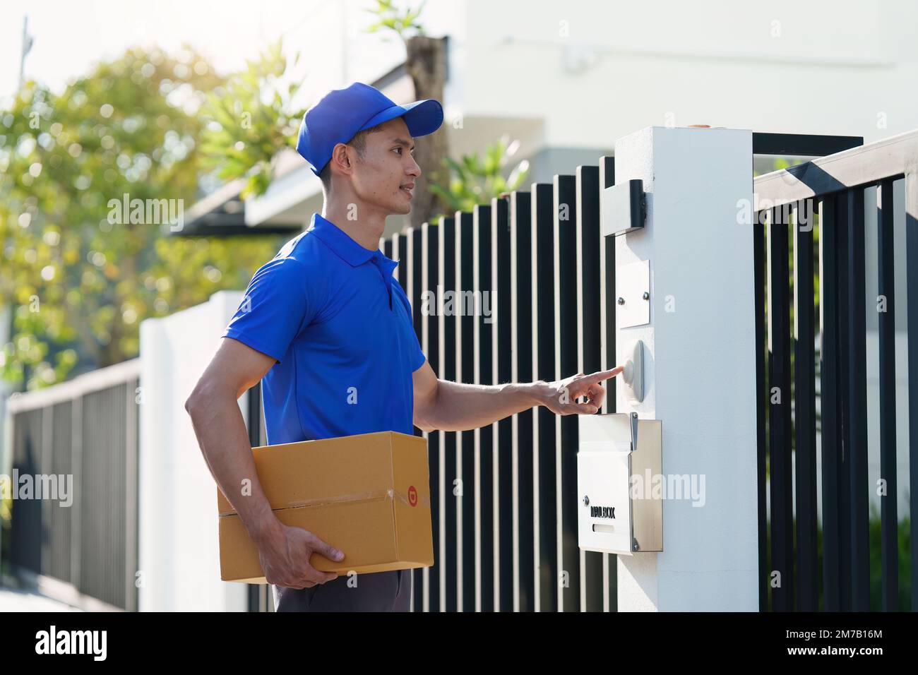 Asian courier with parcel and delivery logistic concept. Delivery man ...