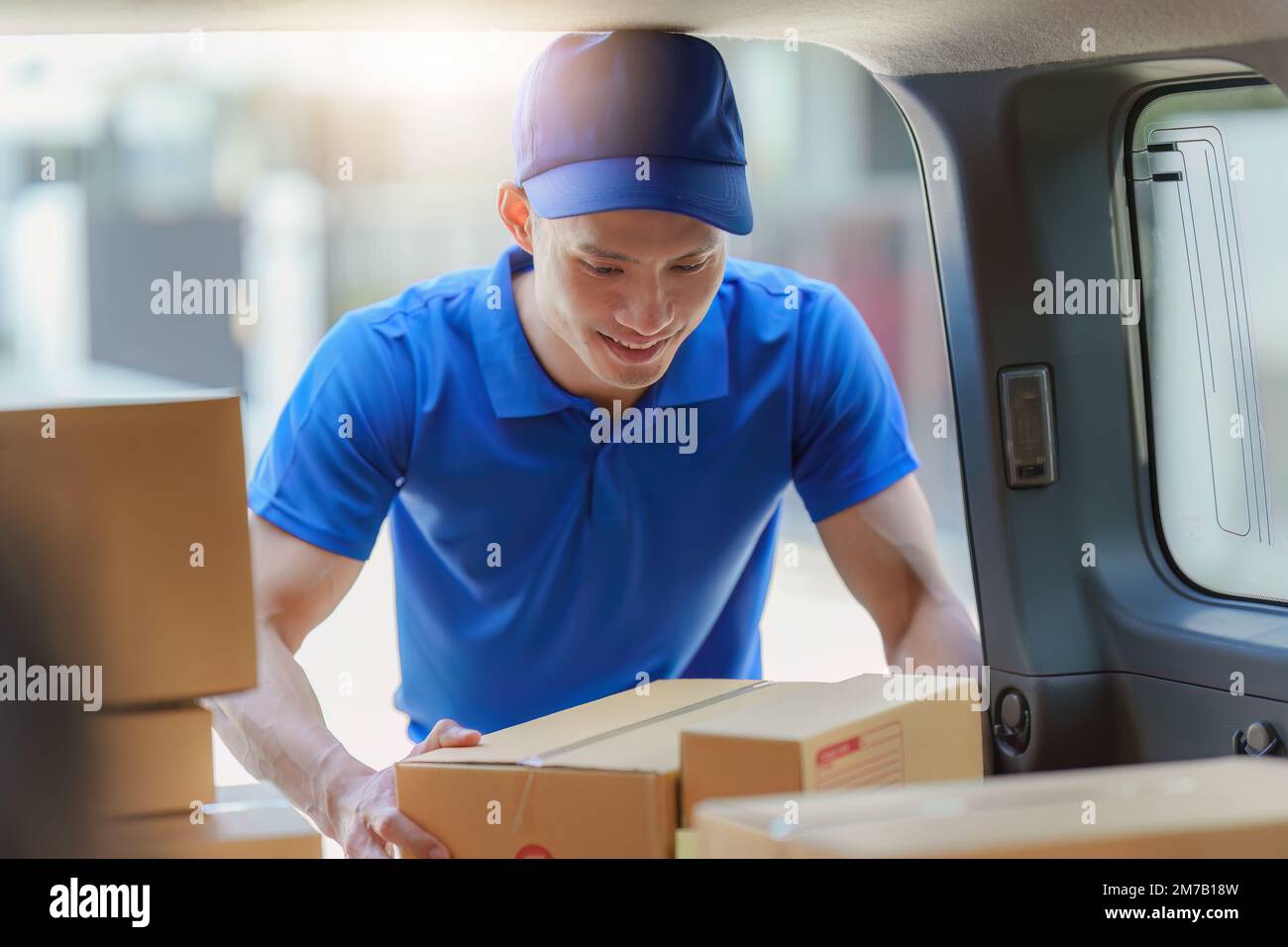 Asian courier with parcel and delivery logistic concept. Delivery man ...