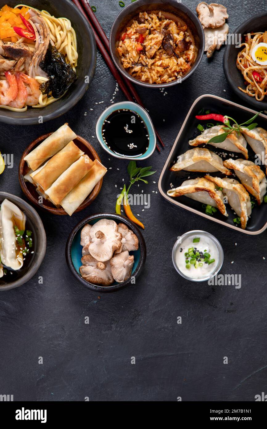 Traditional Asian food. Various of asian meals on dark background. Assorted dishes of ...