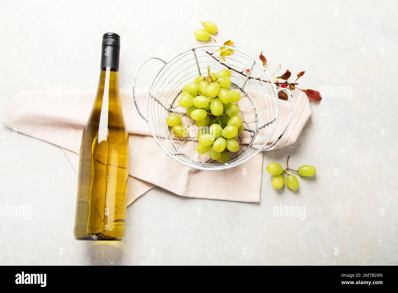 Flat-lay of white wine in glasses and corkscrews on a white background ...