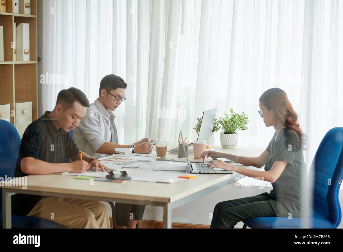 Team of architects and interior designers working on big project ...