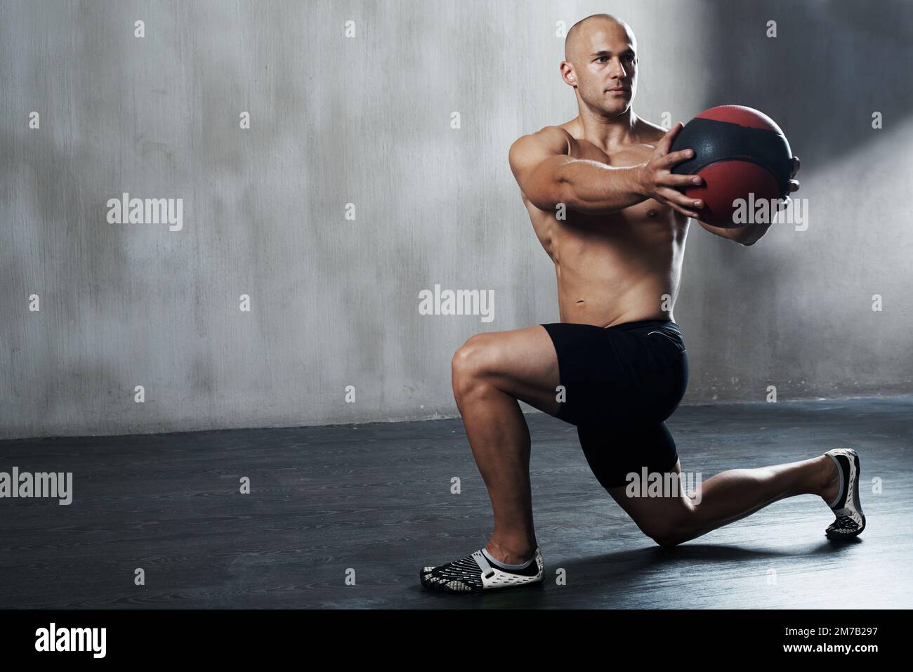 Working those muscles. a man working out with a medicine ball at the ...