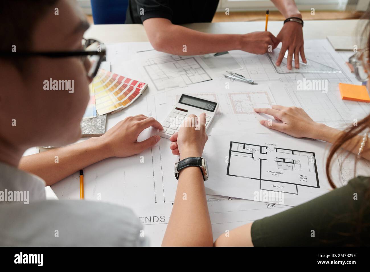 Architects and interior designers measuring rooms dimensions on house ...