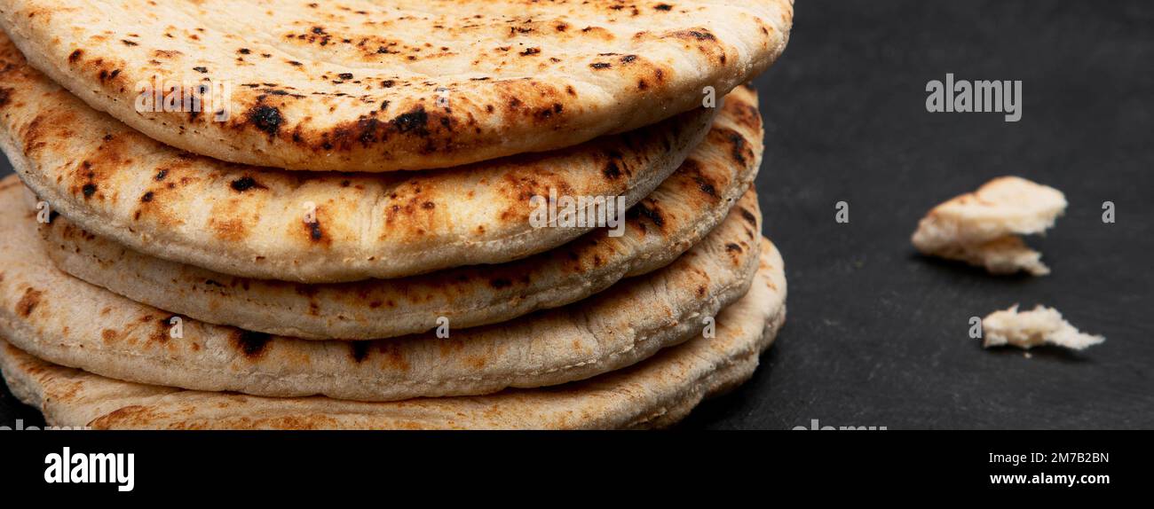 Pita bread isolated on a dark background. Traditional and typical food ...