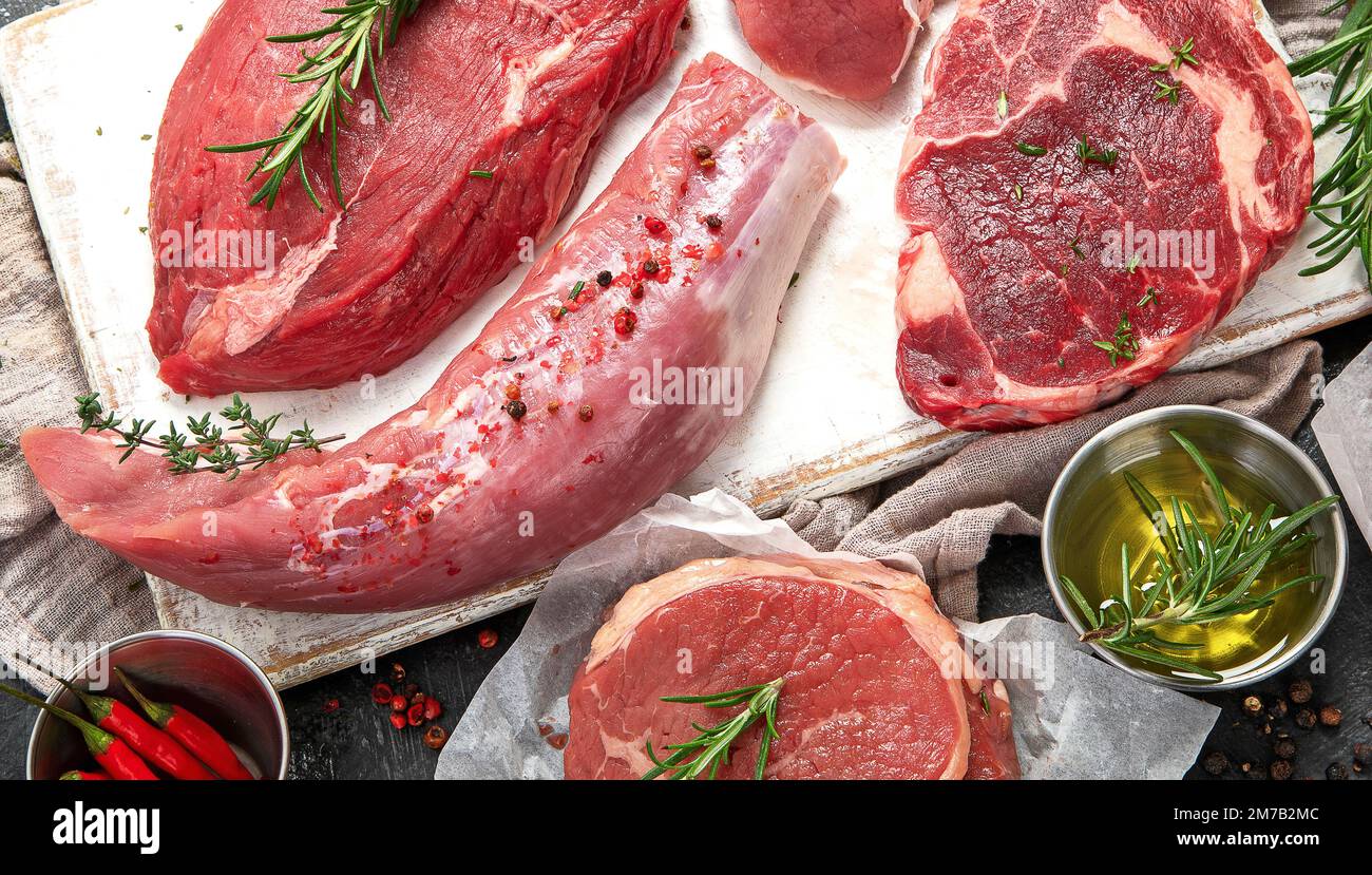 Different types of raw meat - beef, pork, lamb, chicken on dark ...