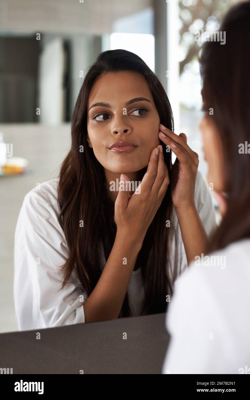 Keeping An Eye Out For Imperfections A Lovely Young Woman Applying