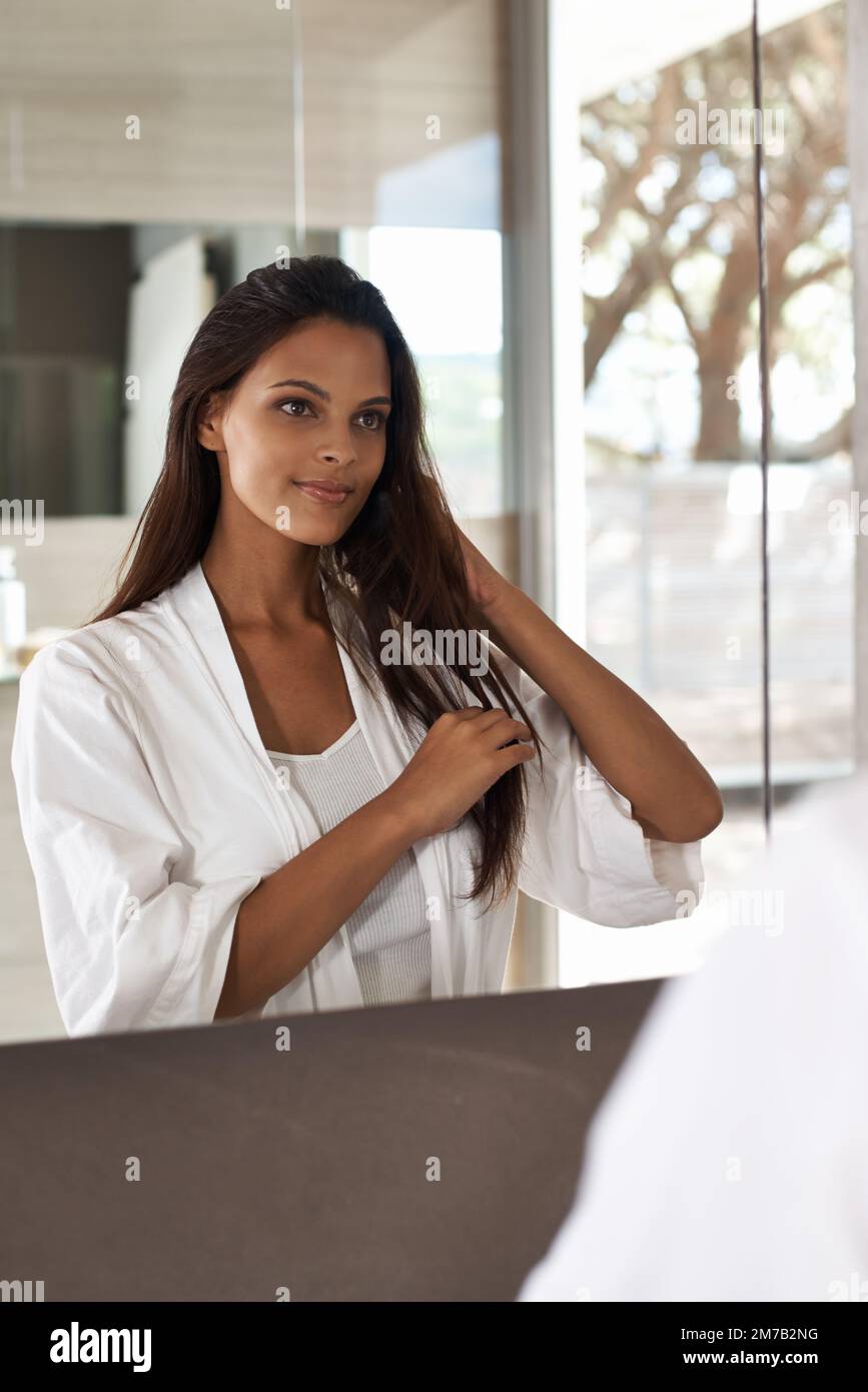 Good morning beautiful. A lovely young woman applying makeup to her ...