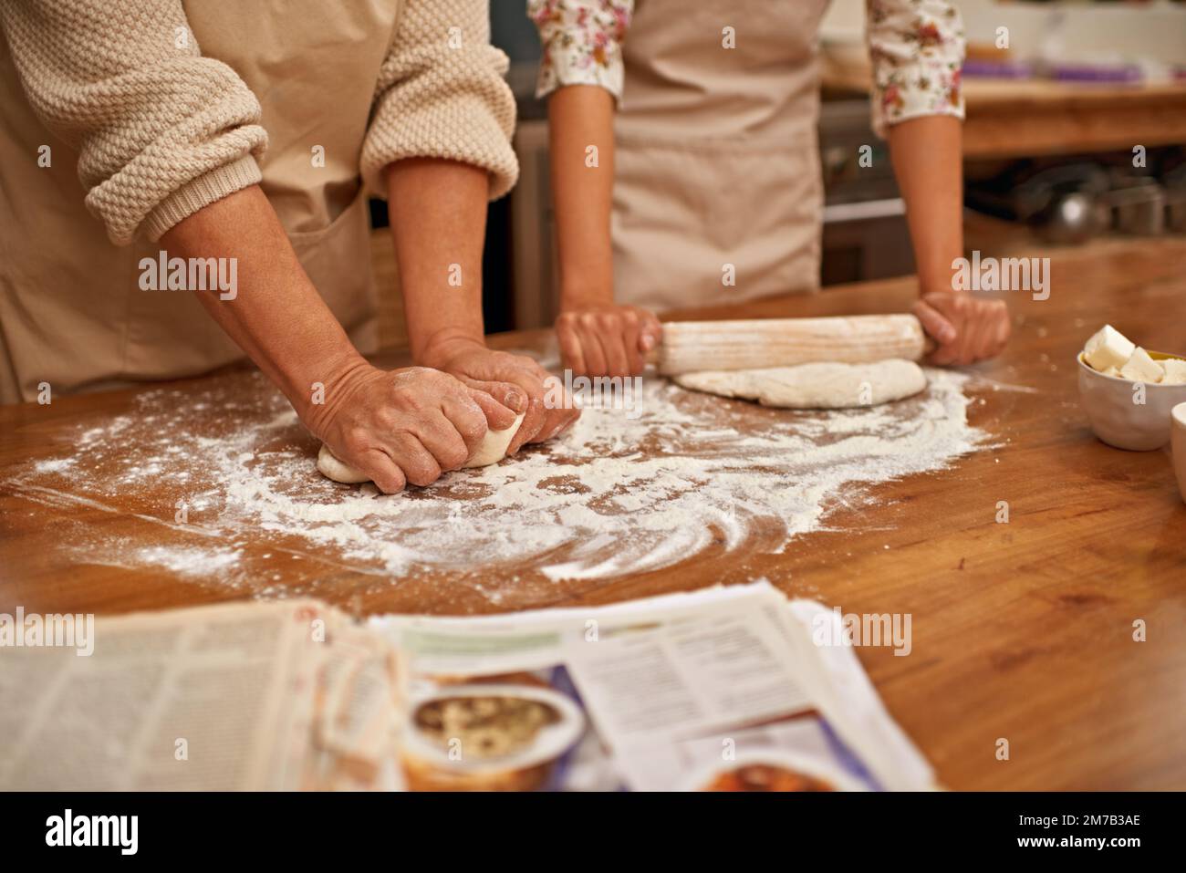 Made with love...A cropped view of hands working the dough while baking ...