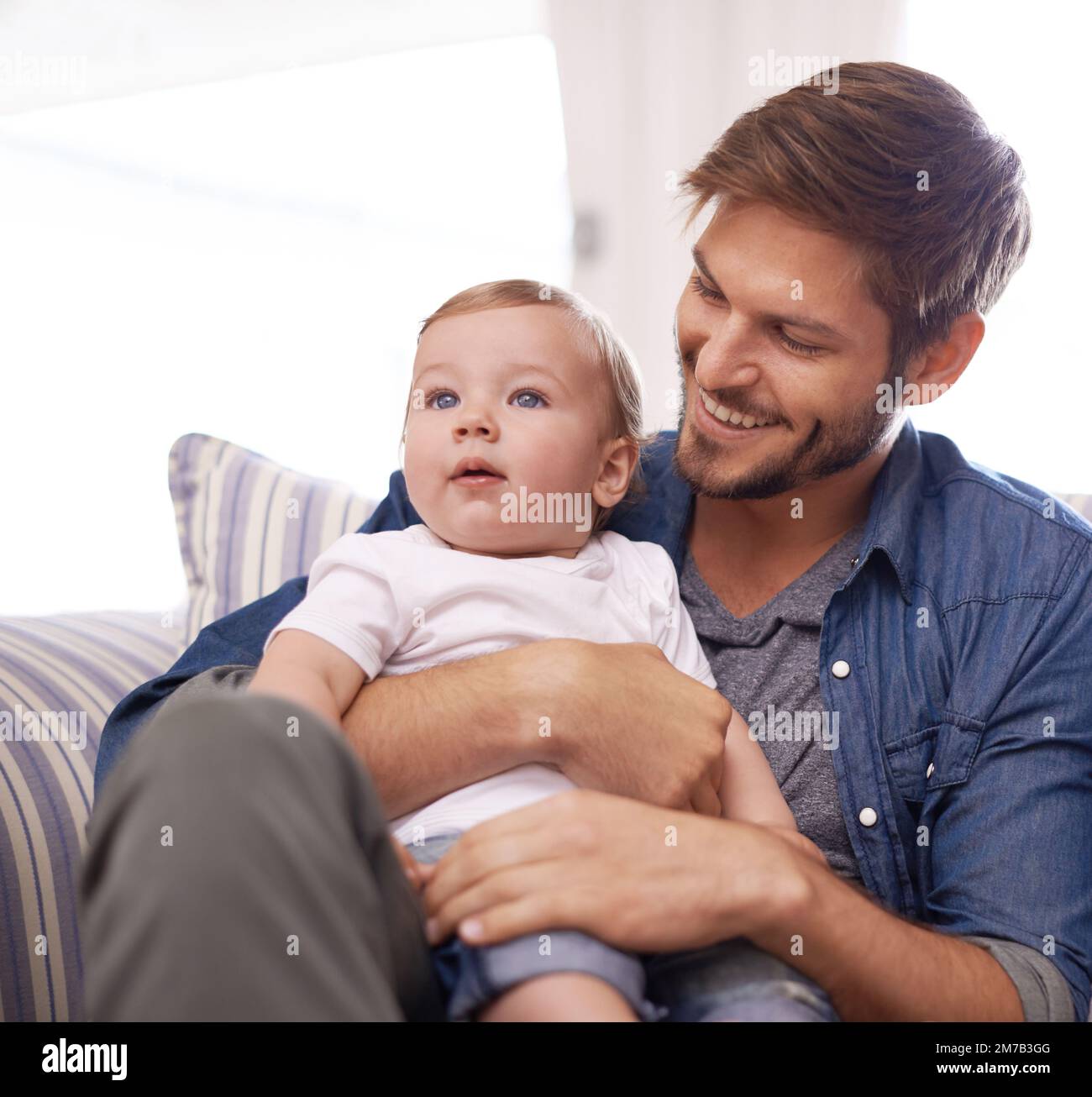 Fatherhood is so fulfilling. A handsome father holding his baby while ...
